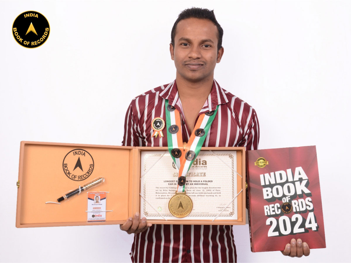 Longest duration to hold a folded ear in place by an individual - India ...